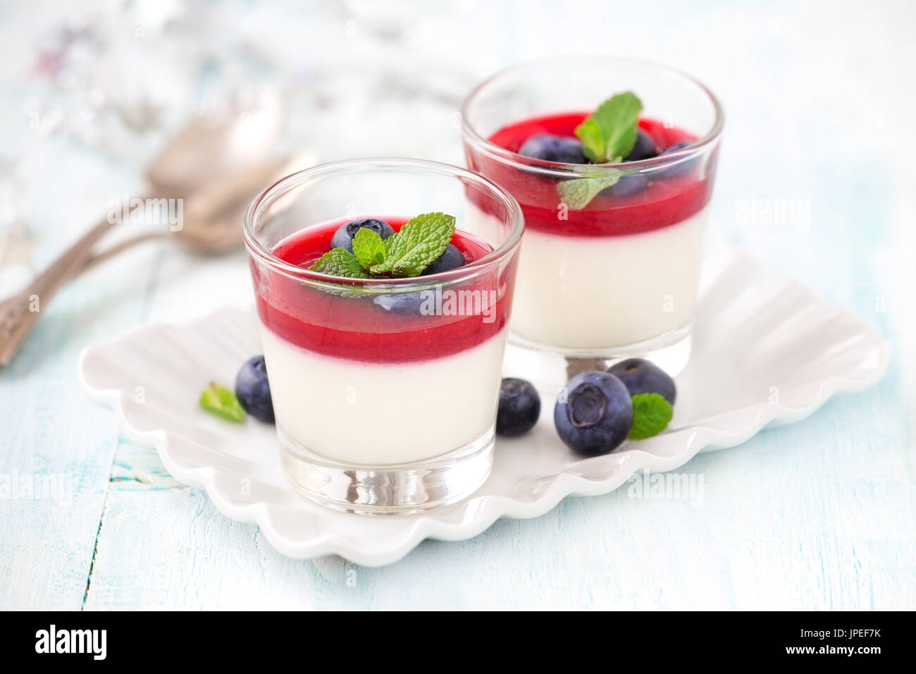 Delicious Italian dessert Panna Cotta with raspberry coulis and fresh ...