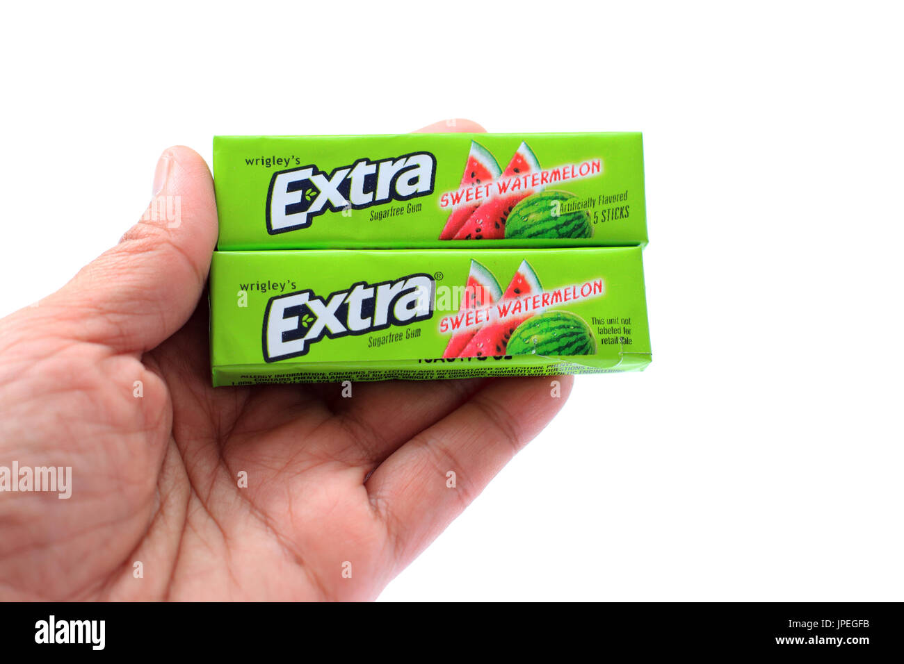 Hand holding Wrigley's Chewing Gum isolated against white background ...