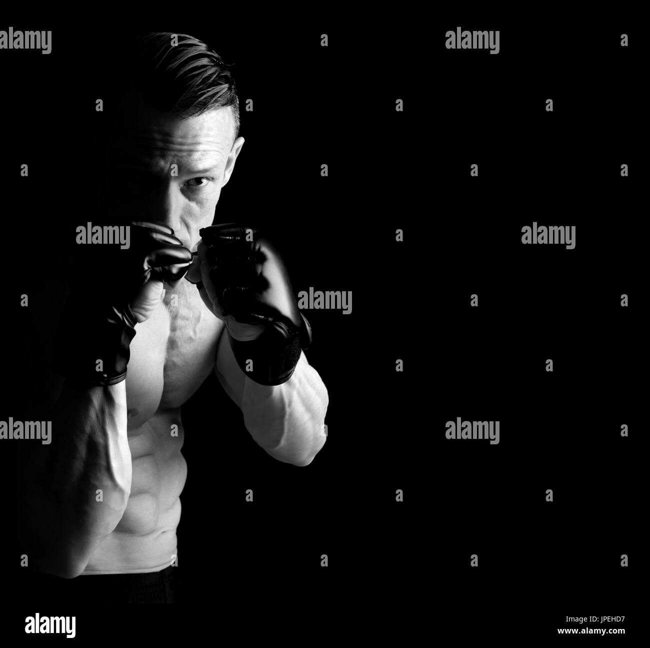 Strong Mixed Martial Arts fighter isolated in black Stock Photo - Alamy