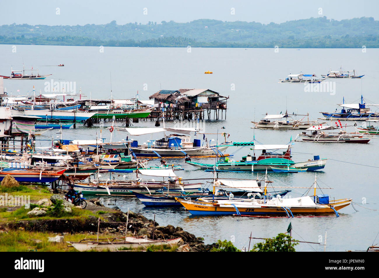 Aerial view of fishing boats and stilt fishing village near port ...