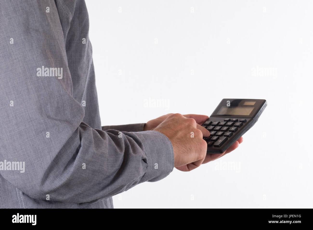 Man doing a calculation on a small simple handheld calculator in a ...