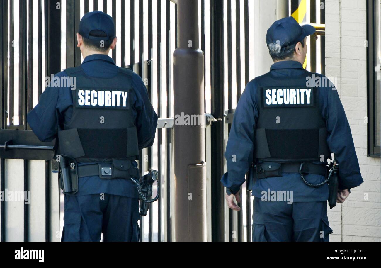 Armed security guards stand at a gate to Akasaka Press Center, a U.S ...