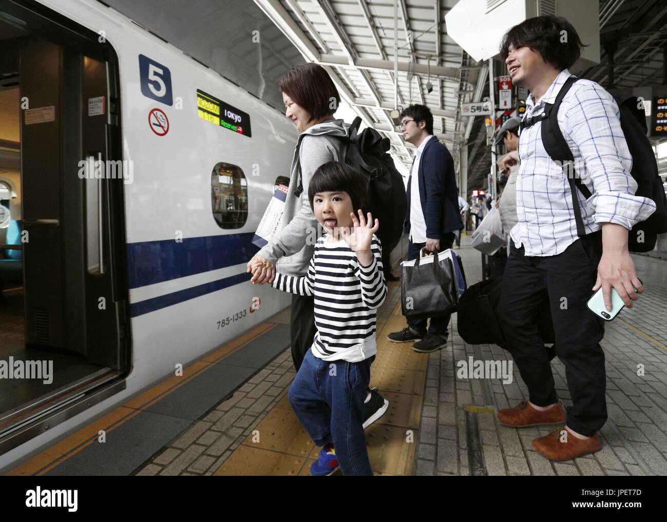 A shinkansen bullet train platform at JR Shin-Osaka station is crowded ...