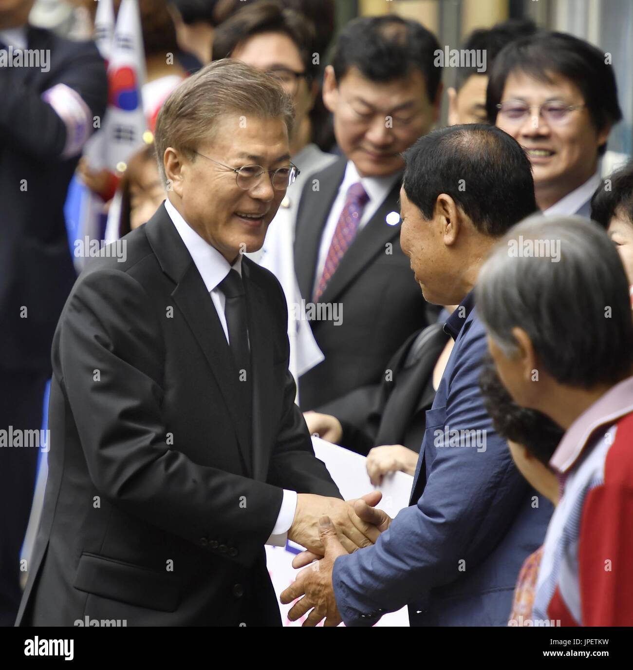 South Korea's new president, Moon Jae In, shakes hands with people in ...