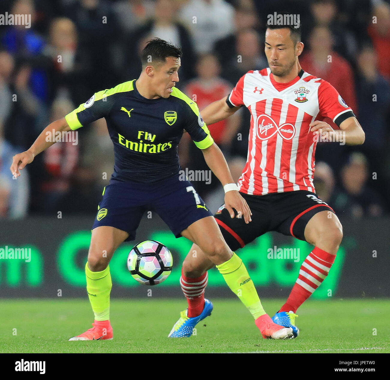 Arsenal's Alexis Sanchez (L) and Maya Yoshida of Southampton vie for ...