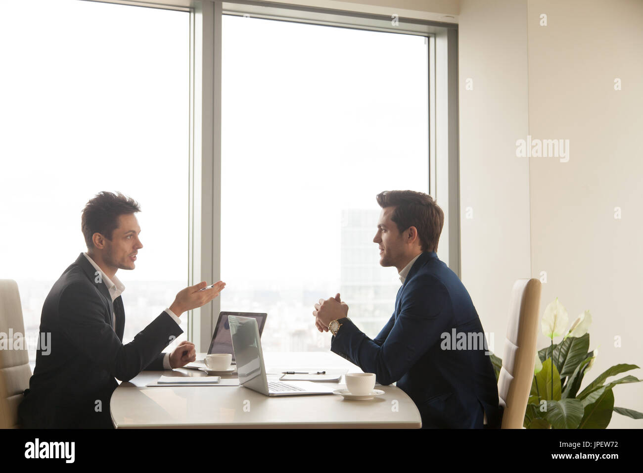 Male entrepreneur talking partners on hi-res stock photography and ...