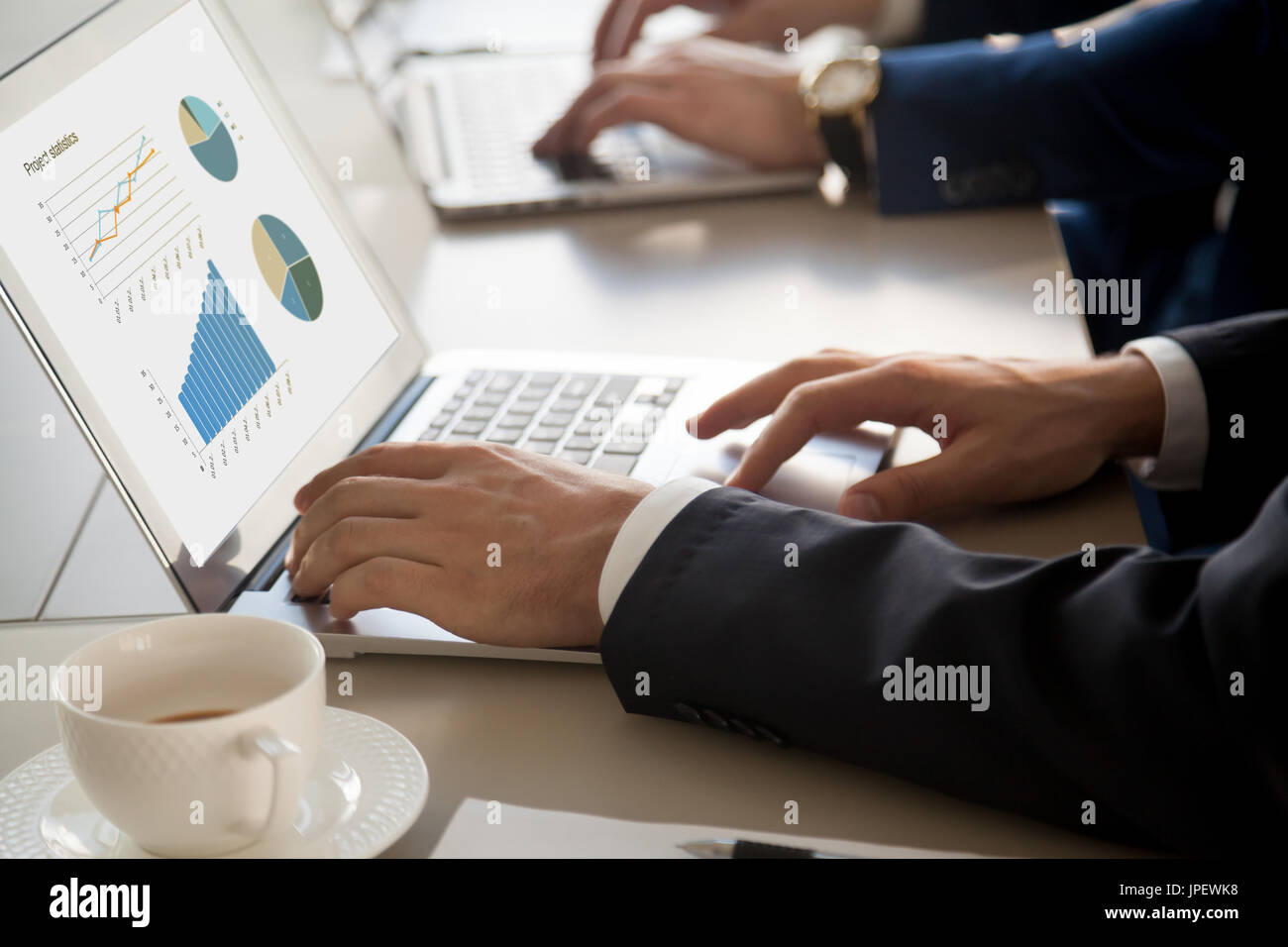 Businessman using laptop, project statistics on screen, close up Stock ...