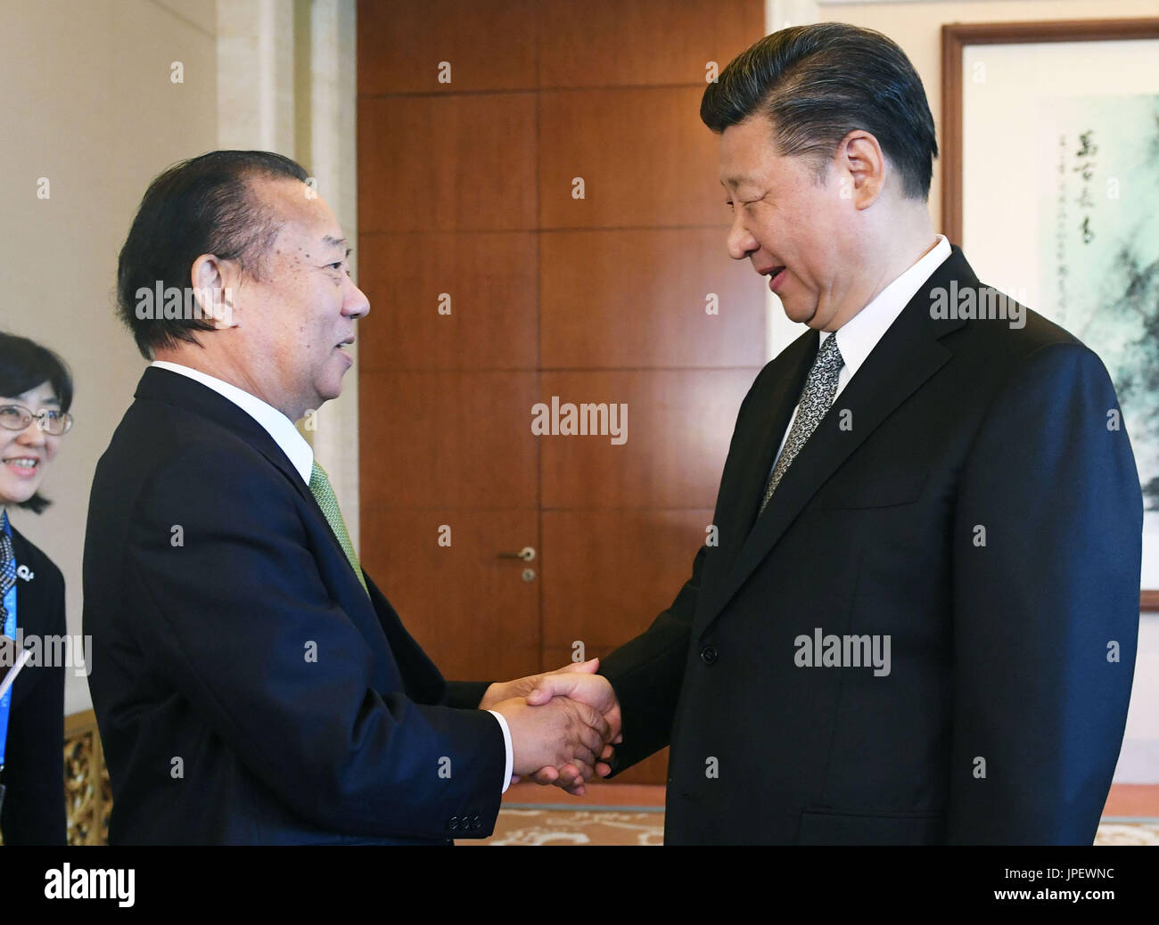 Chinese President Xi Jinping (R) and Toshihiro Nikai, secretary general ...