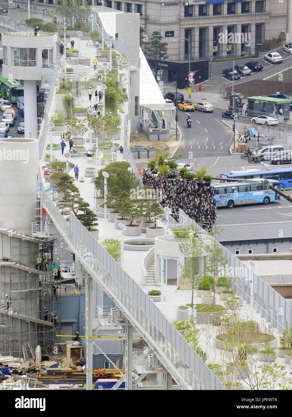 An elevated pedestrian pathway, adorned with flower beds, in Seoul is ...