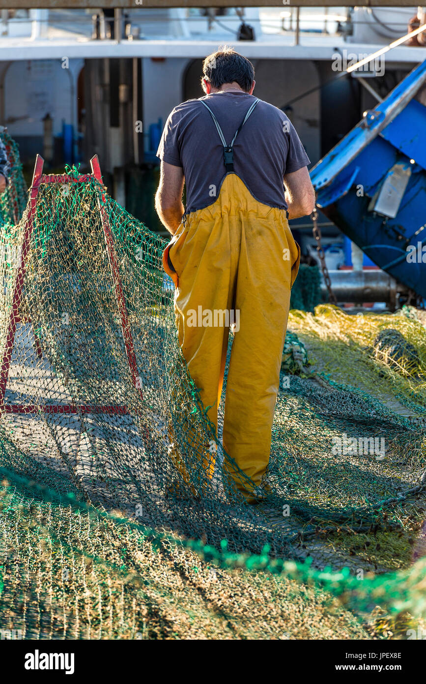 Fishing port men mending nets hi-res stock photography and images - Alamy