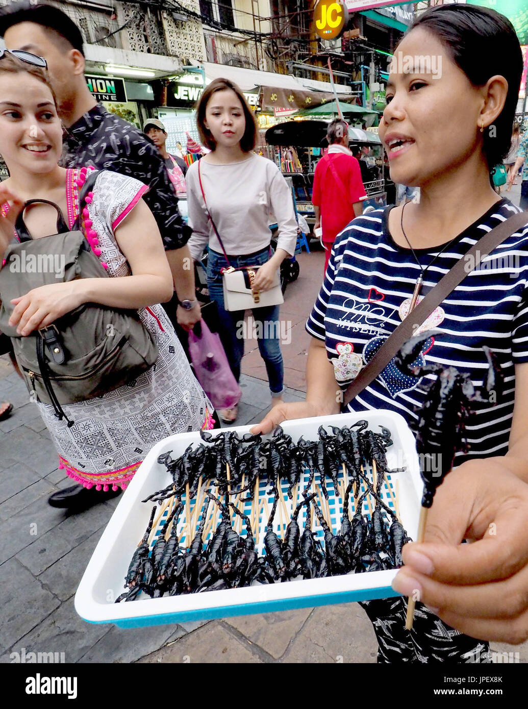 A woman sells fried scorpions in a tourist spot in Bangkok on May 13 ...