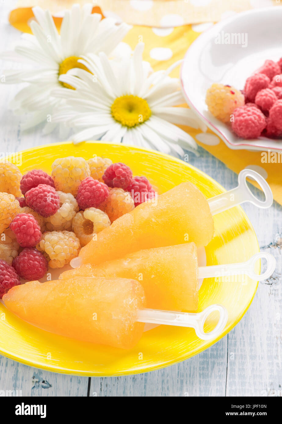 Fruit ice cream yellow raspberry with mixed berries raspberries on a ...