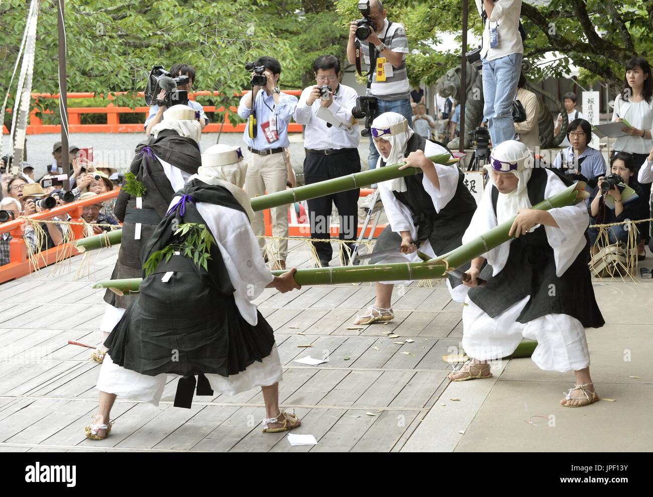 Priests chop green bamboo logs, representing a big snake, during a ...