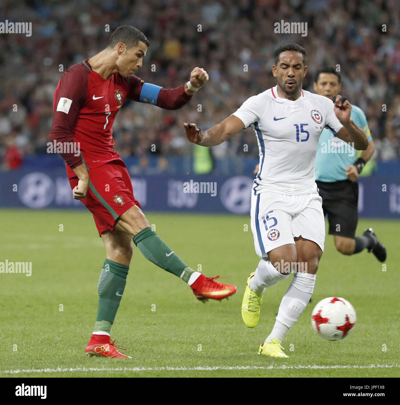 Portugal's Cristiano Ronaldo (L) shoots past Jean Beausejour of Chile ...