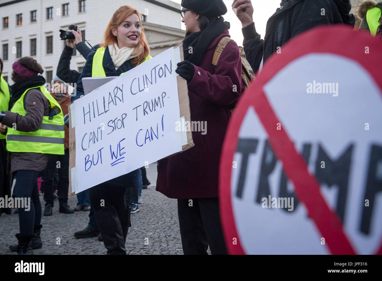 An American expat holding an anti-Trump placard in front of the US ...