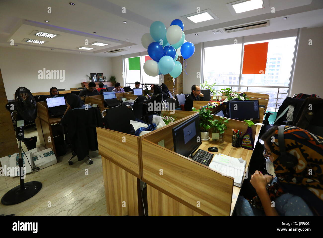 Staff at the headquarters of the Snaap online taxi service in Tehran ...