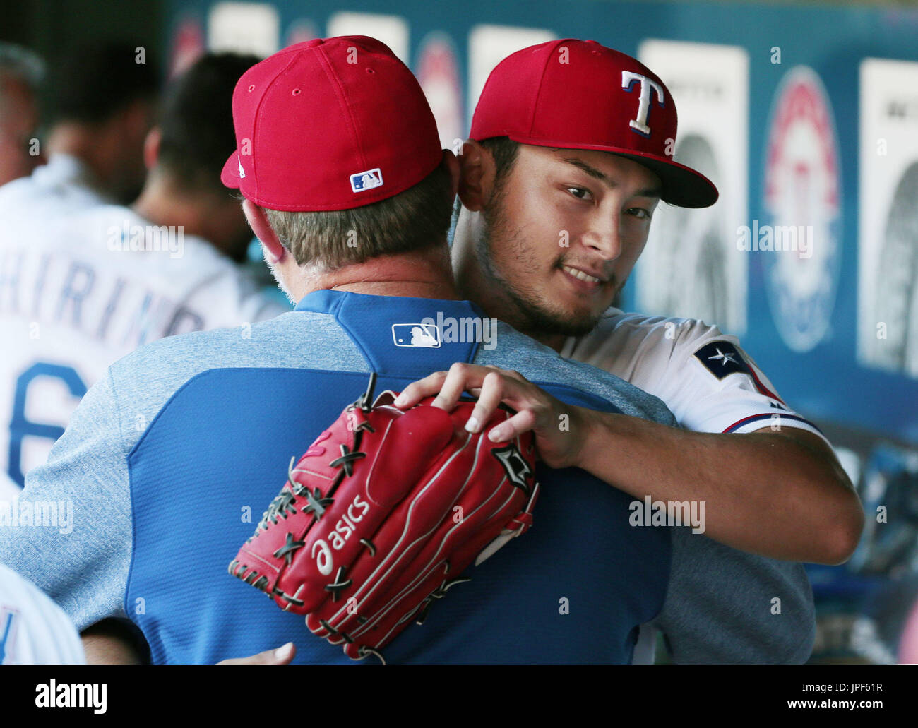 Texas Rangers pitcher Yu Darvish is hugged by pitching coach Doug ...