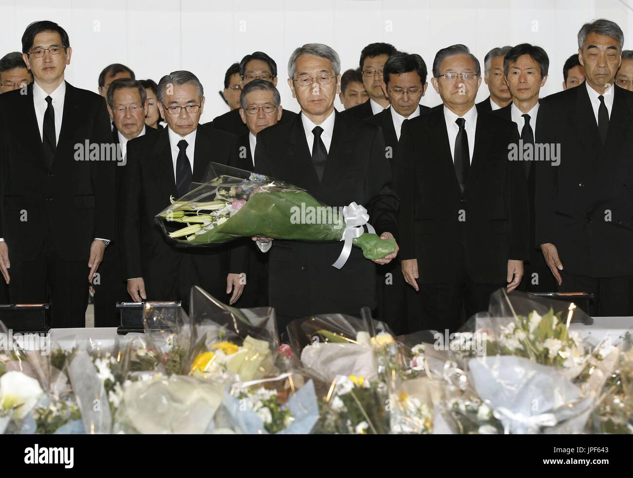 West Japan Railway Co. President Tatsuo Kijima (C) prepares to lay flowers in Amagasaki, Hyogo ...