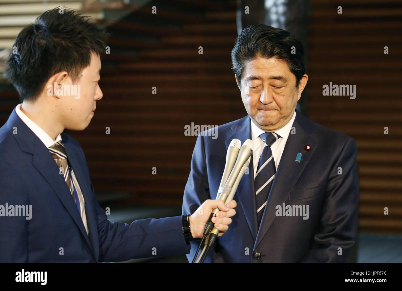 Japanese Prime Minister Shinzo Abe (R) speaks at his office in Tokyo on ...