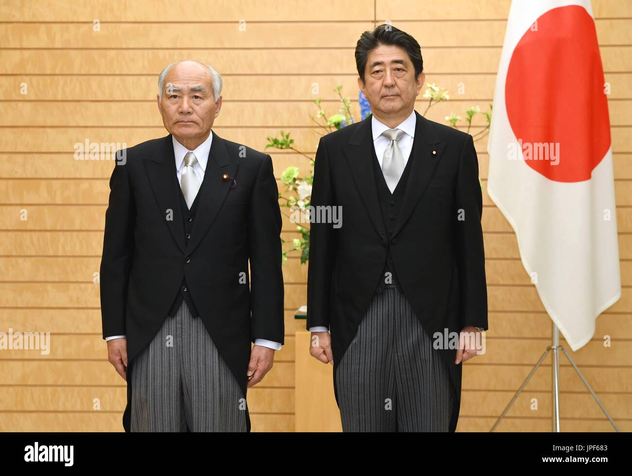 Japan's new disaster reconstruction minister Masayoshi Yoshino (L ...