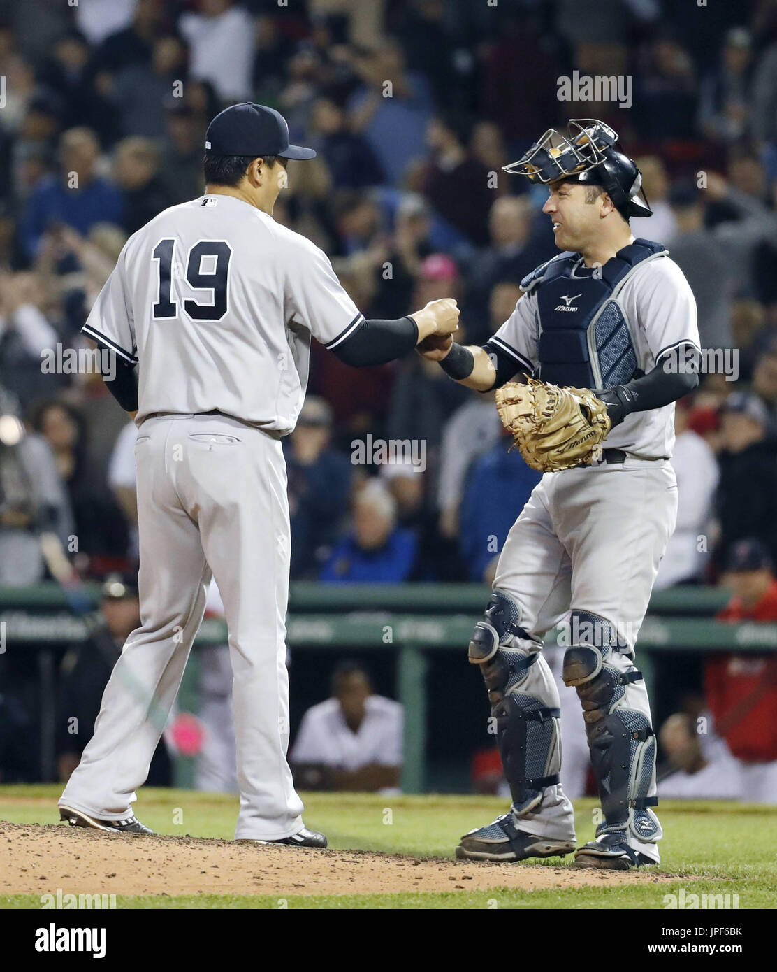 New York Yankees pitcher Masahiro Tanaka (L) bumps fists with catcher Austin Romine after ...