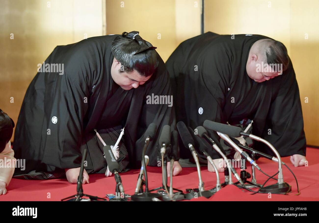 Sumo wrestler Takayasu (L), alongside his stablemaster Tagonoura, bows ...