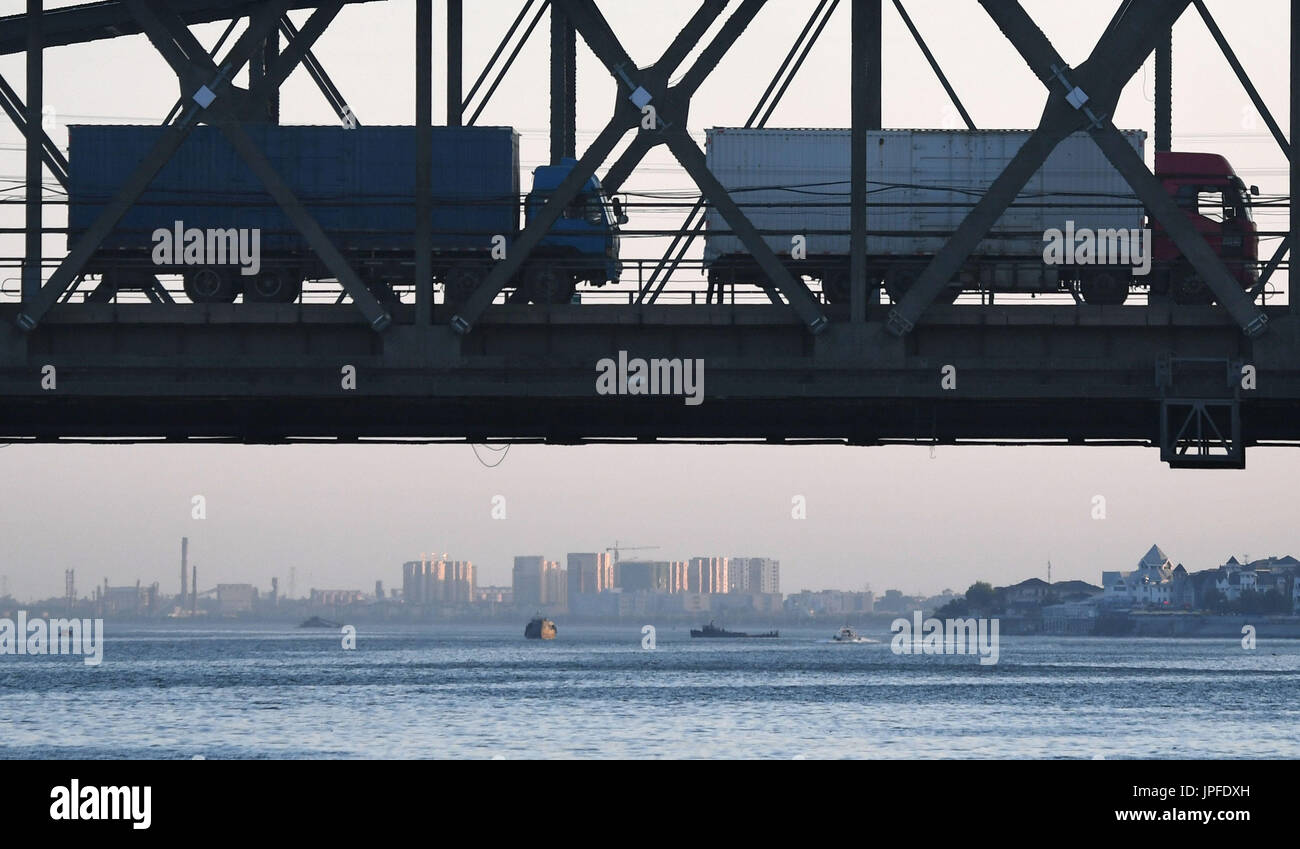 Trucks run across the Sino-Korean Friendship Bridge, connecting North ...