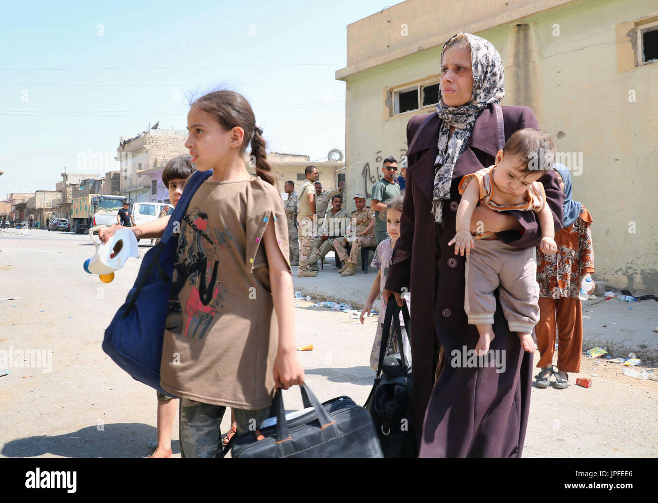 People look exhausted in the northern Iraqi city of Mosul on July 10 ...