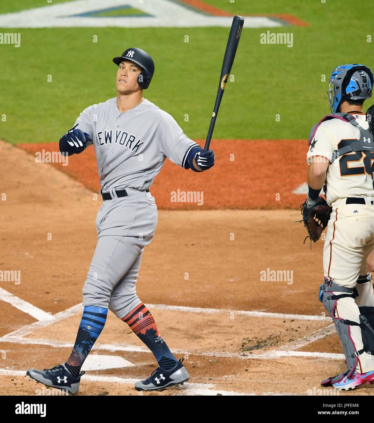 Aaron Judge (L) of the New York Yankees strikes out in the first inning ...