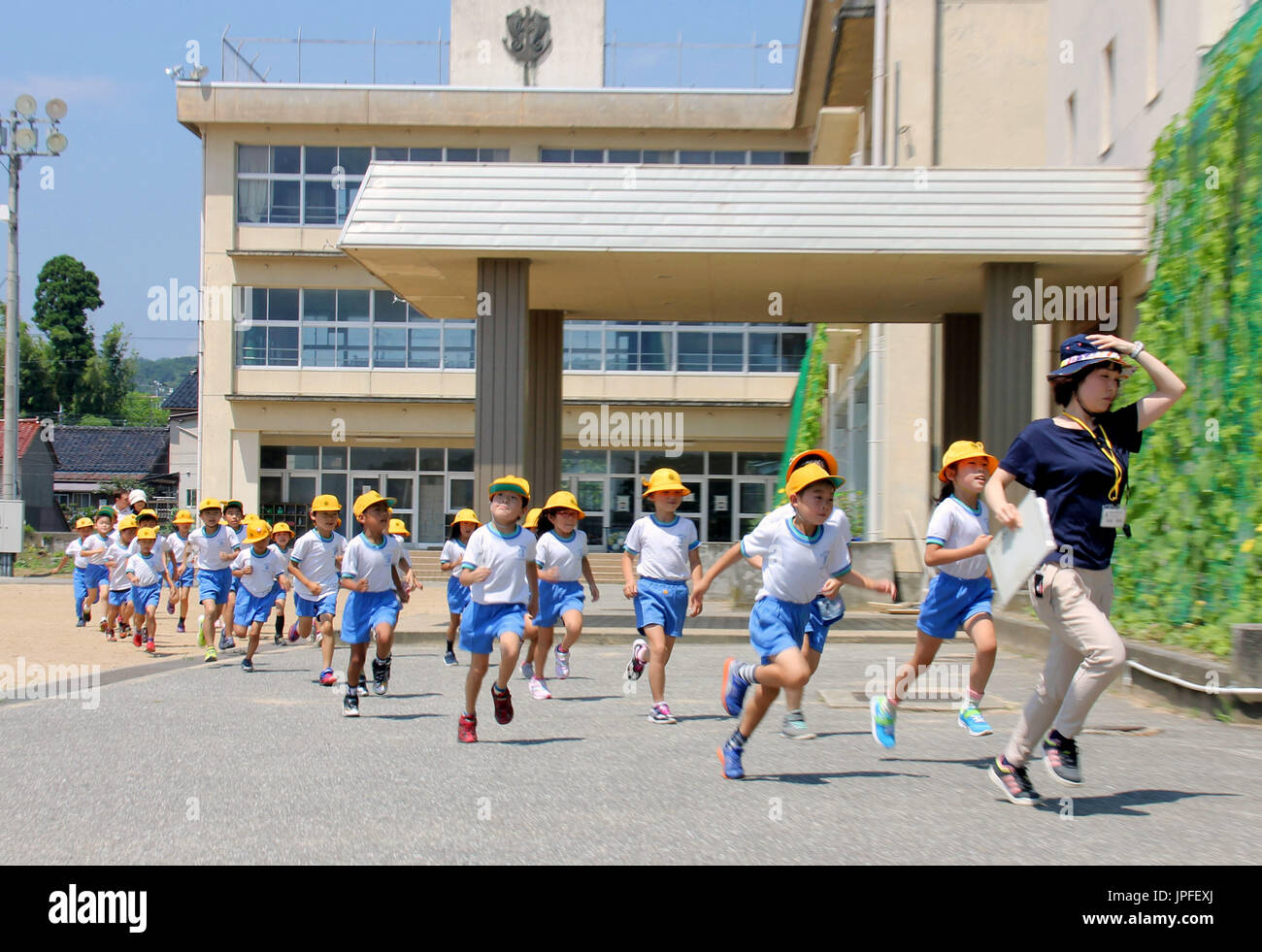 Elementary school students participate in an evacuation drill in the ...