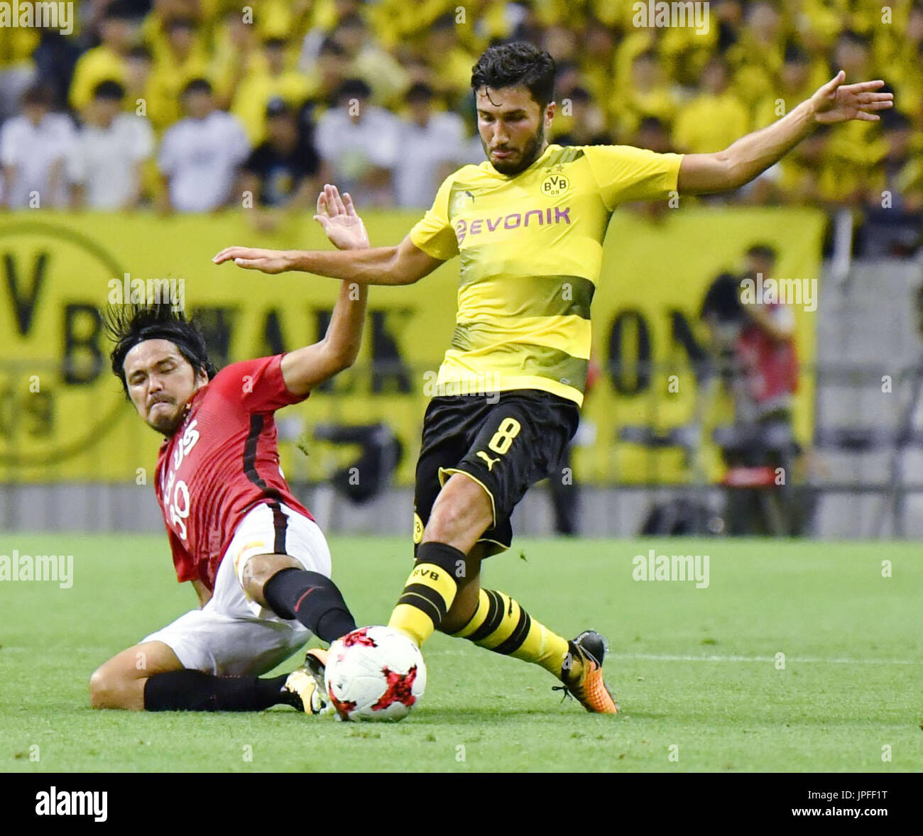 Shinzo Koroki (L) of Urawa Reds and Nuri Sahin of Borussia Dortmund vie ...