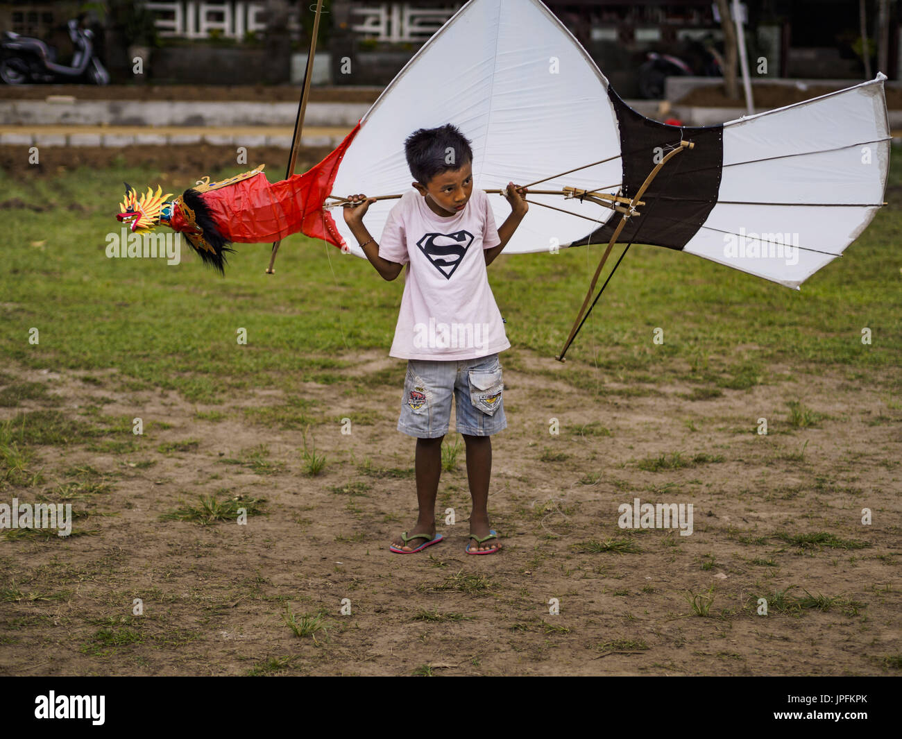 Ubud, Bali, Indonesia. 1st Aug, 2017. A boy carries his janggan (bird ...