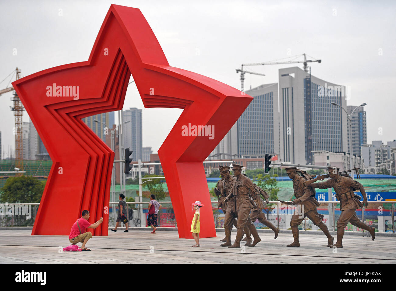 Nanchang, July 31. 1st Aug, 1927. A girl poses with sculptures marking ...