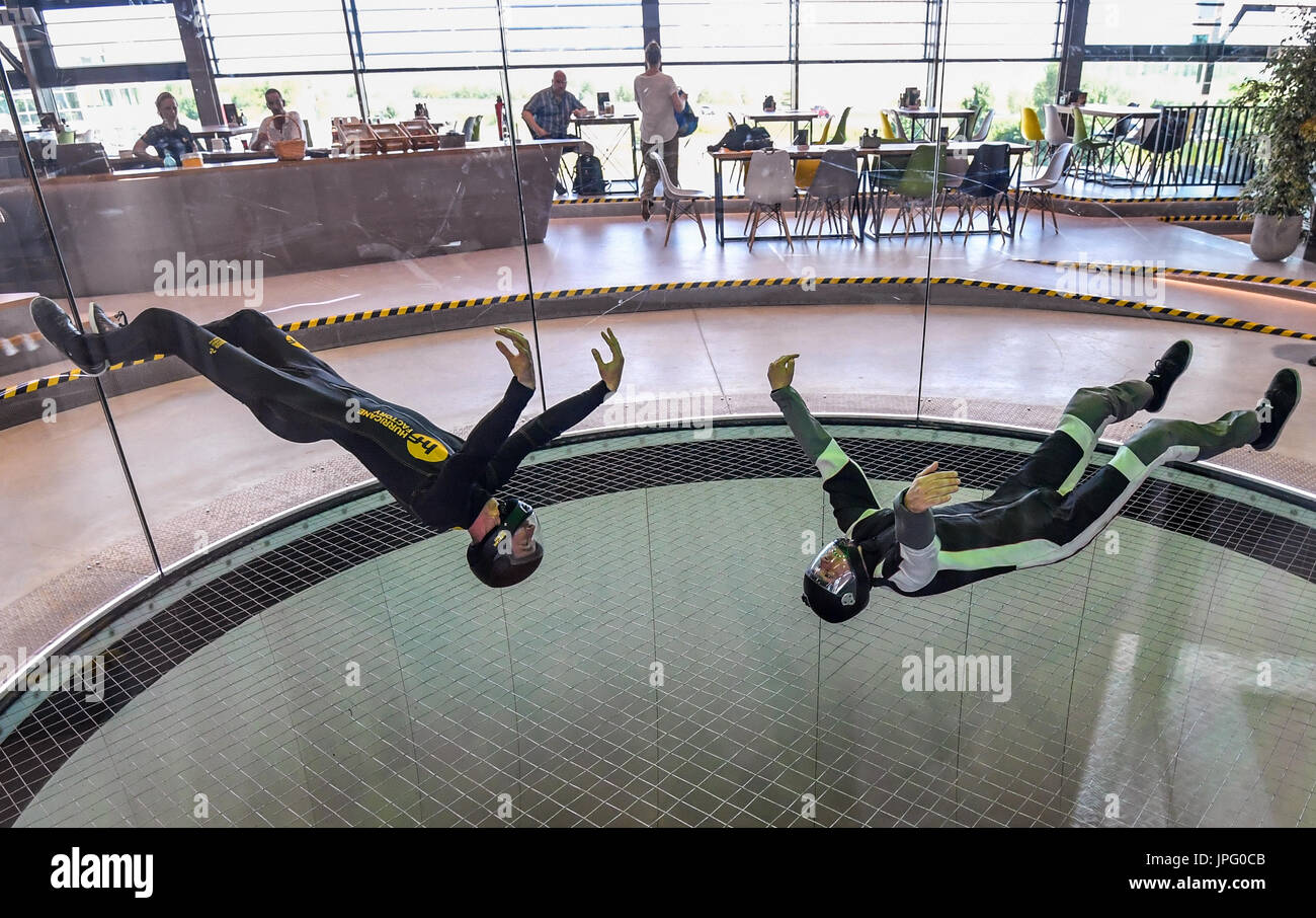 Two men fly seemingly weightless in a wind tunel of the Hurricane ...