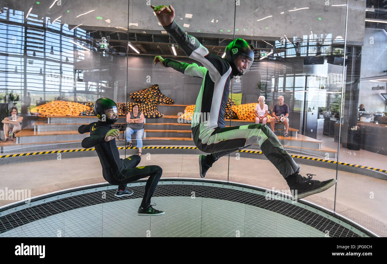 Two men fly seemingly weightless in a wind tunel of the Hurricane ...