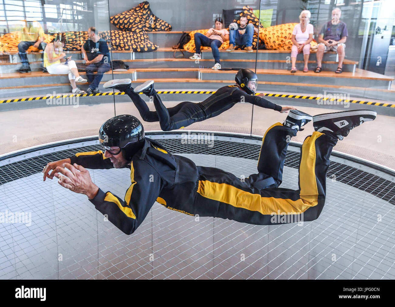 Two men fly seemingly weightless in a wind tunel of the Hurricane ...
