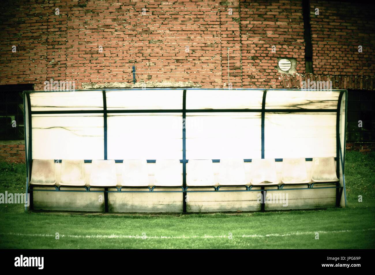 Old plastic seats on outdoor stadium players bench, chairs with worn ...