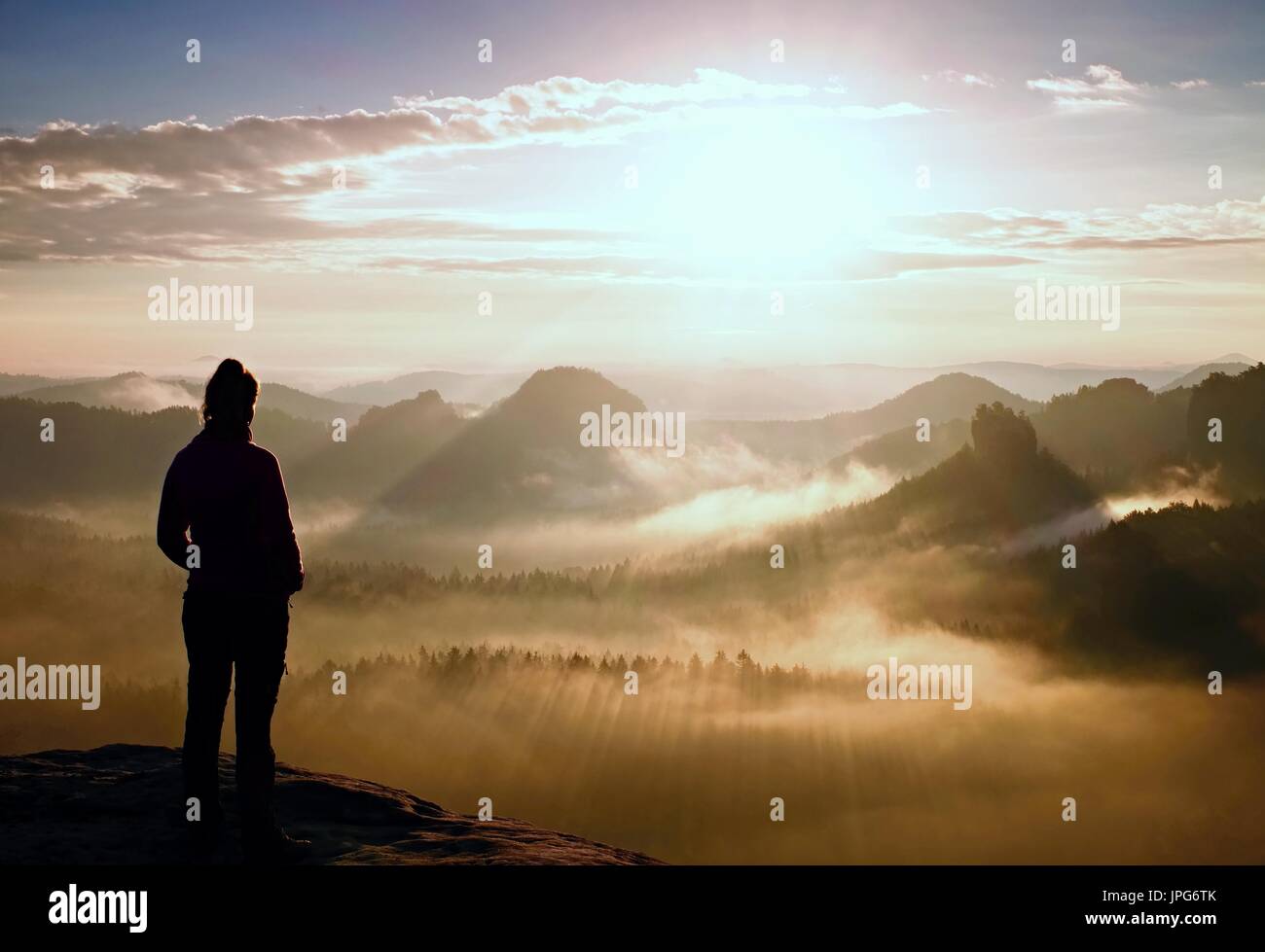 Alone young girl tourist feast daybreak on the sharp corner of ...