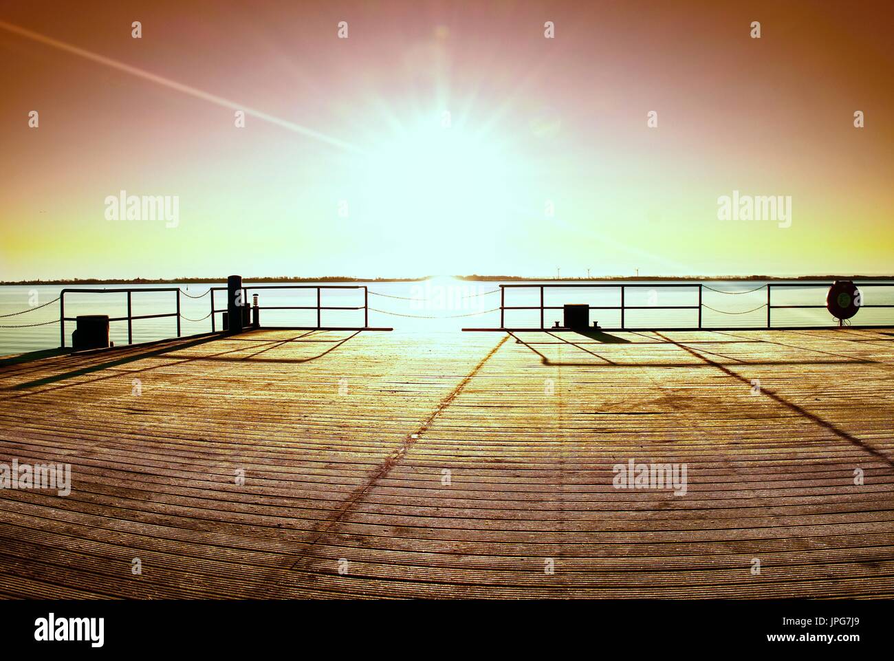 Empty wooden pier at beautiful colorful morning. Tourist wharf in bay ...