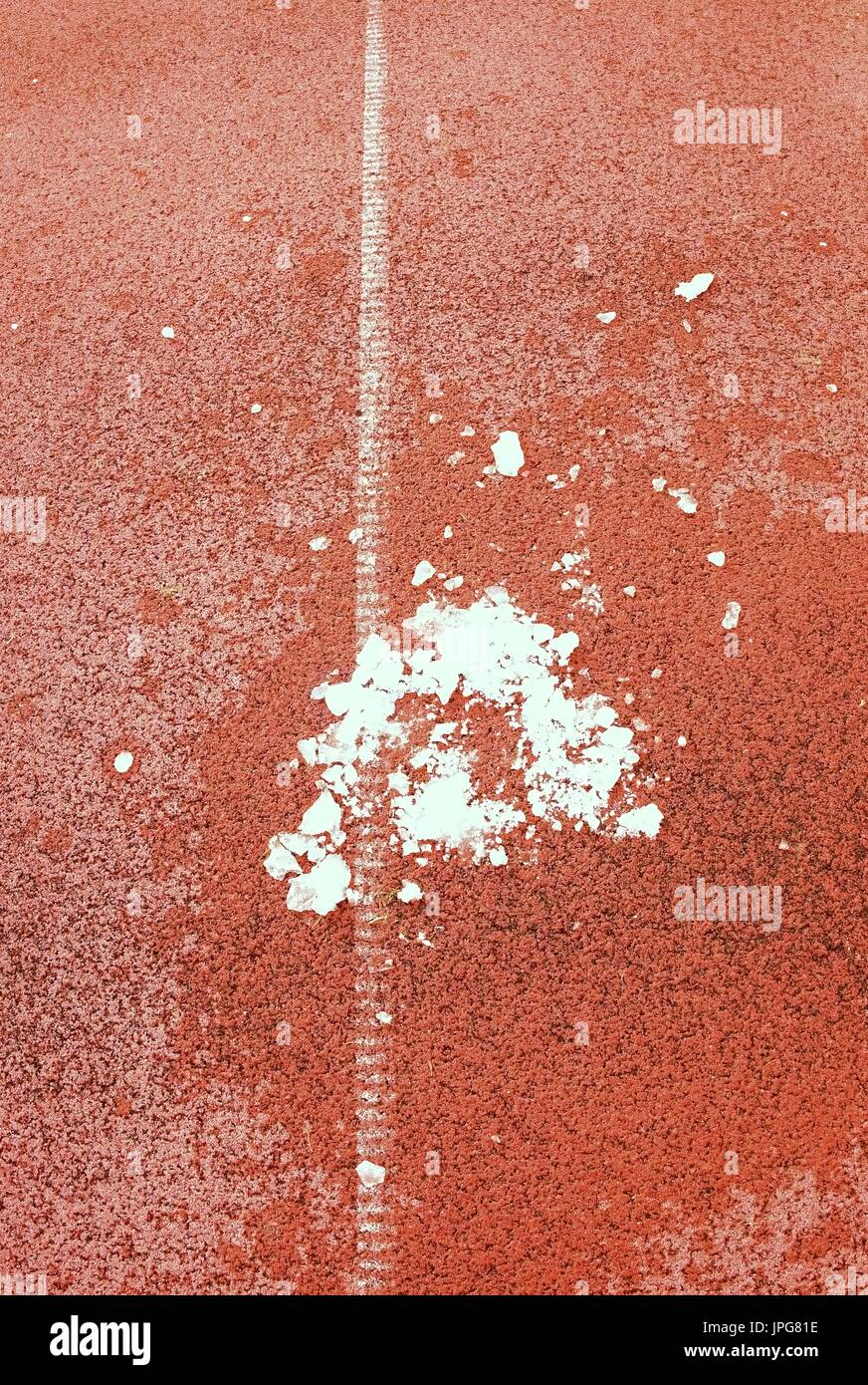 Snow on ground. White lines and texture of running racetrack, red ...