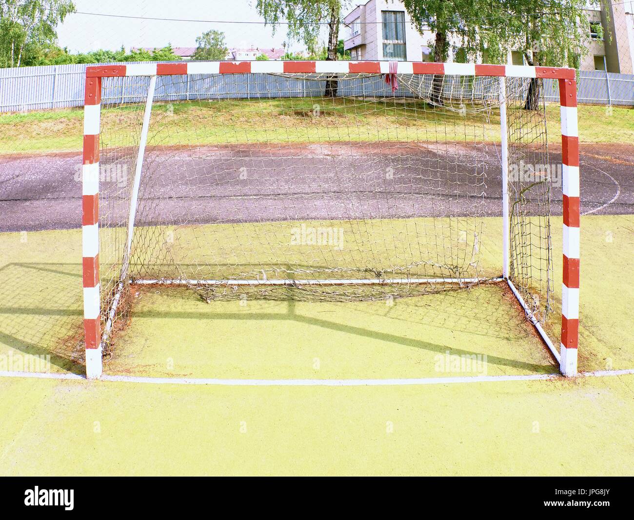 Gate for small football or handball in small stadium. Lit green hairy ...