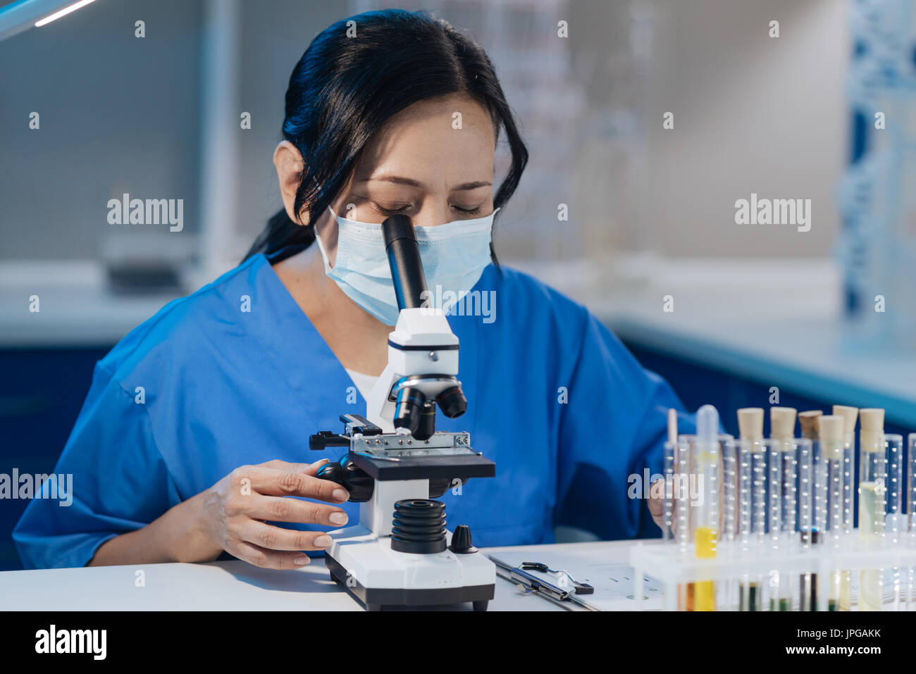 Smart professional biologist studying microorganisms Stock Photo - Alamy