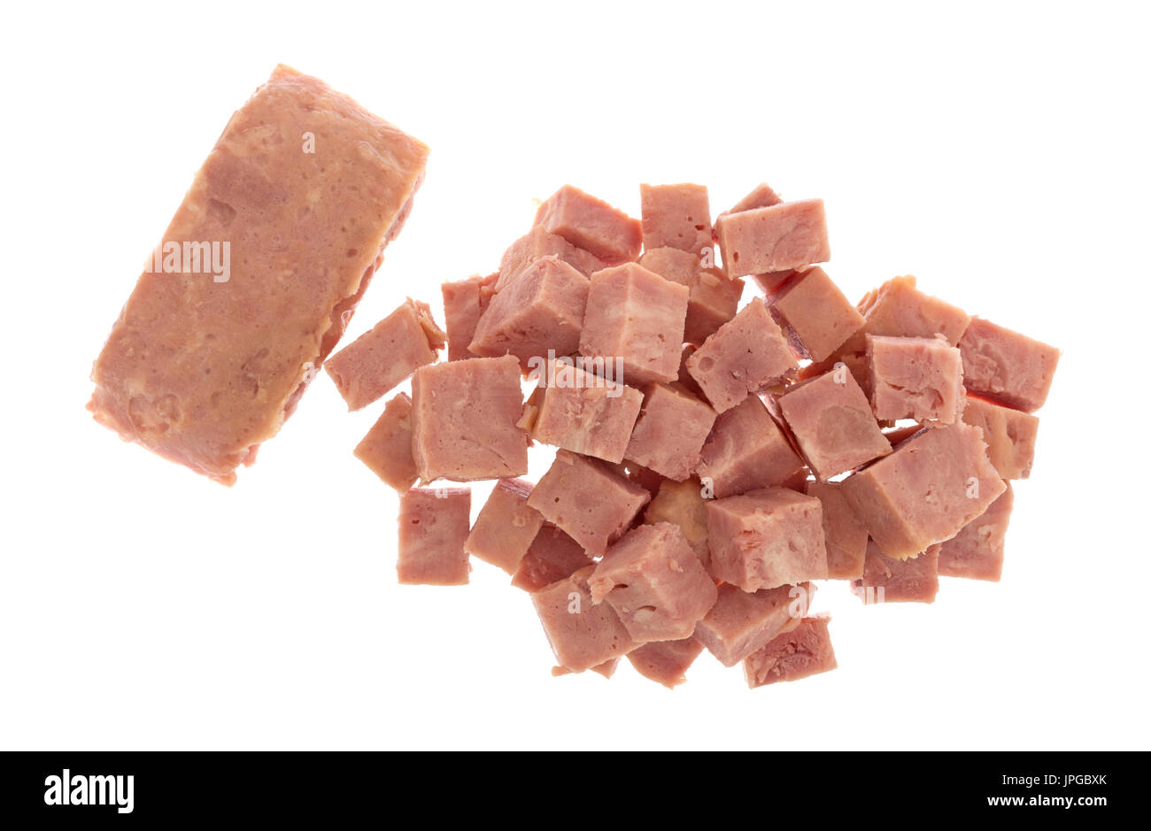 Top view of canned ham that has been cut into chunks with one large ...