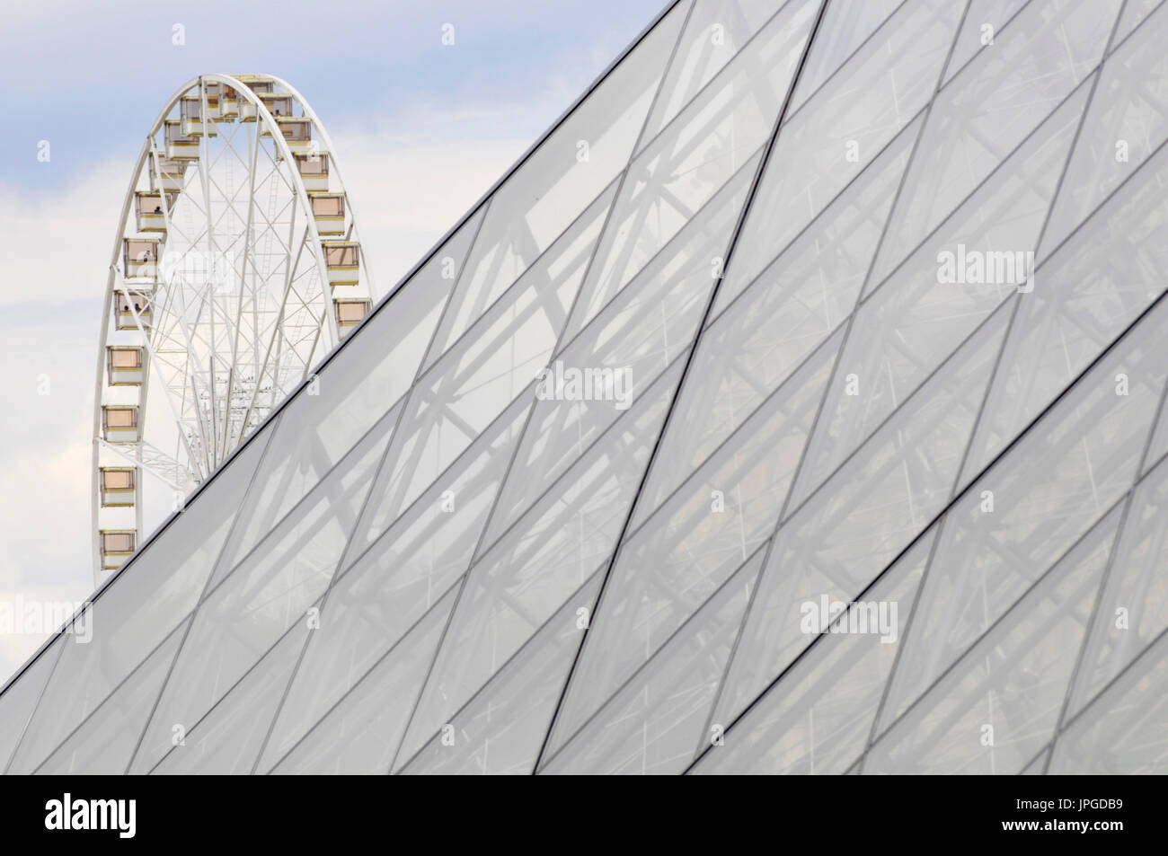 Detail of Louvre glass pyramid and The Big Wheel Ferris wheel in the ...