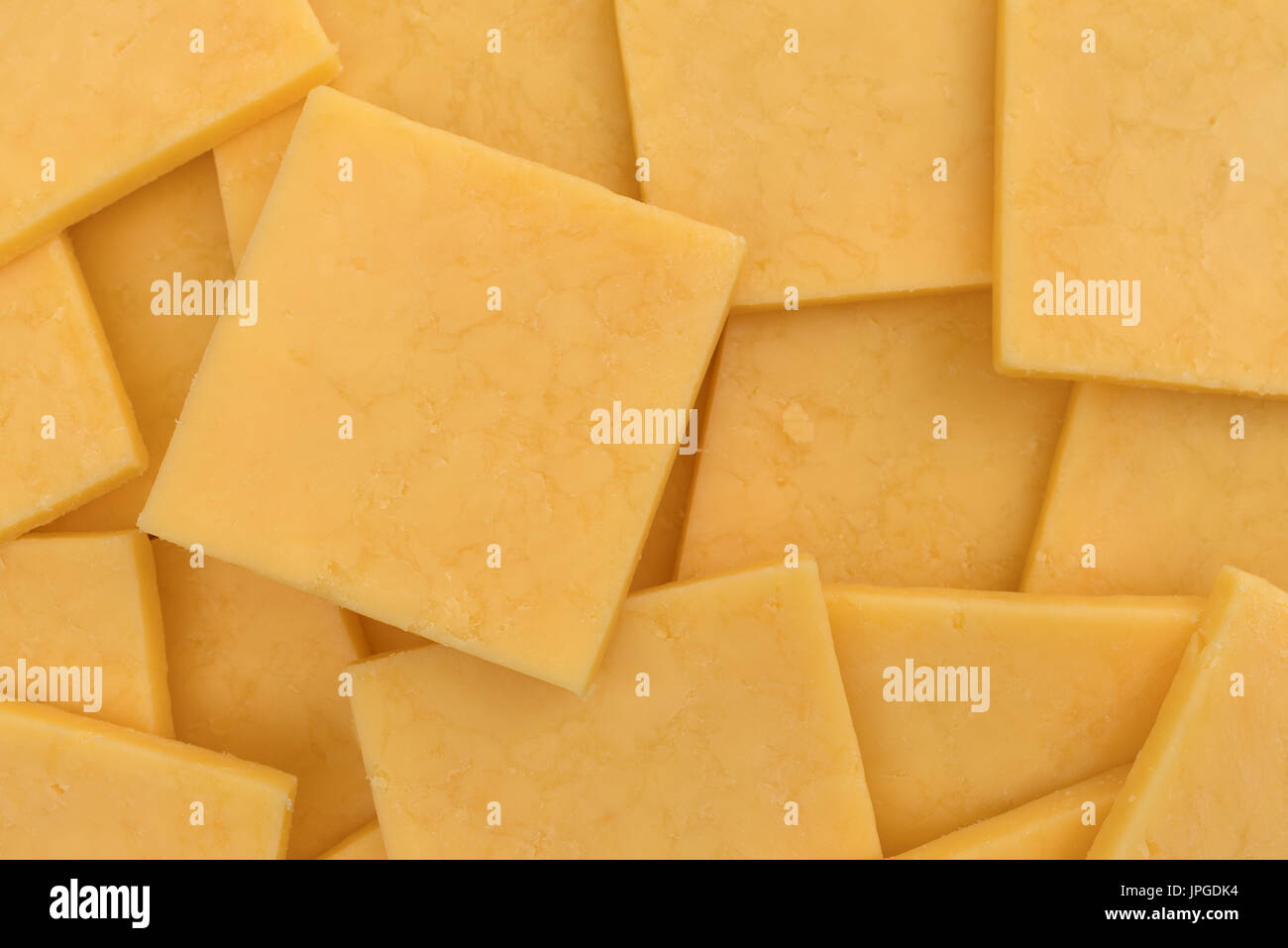 Top close view of several square slices of gouda cheese Stock Photo - Alamy