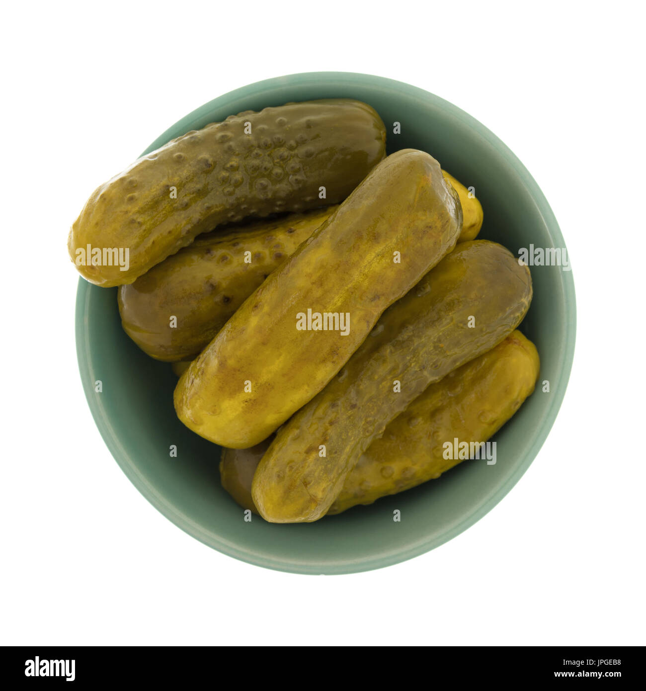 Top view of a bowl filled with kosher baby dill pickles isolated on a ...