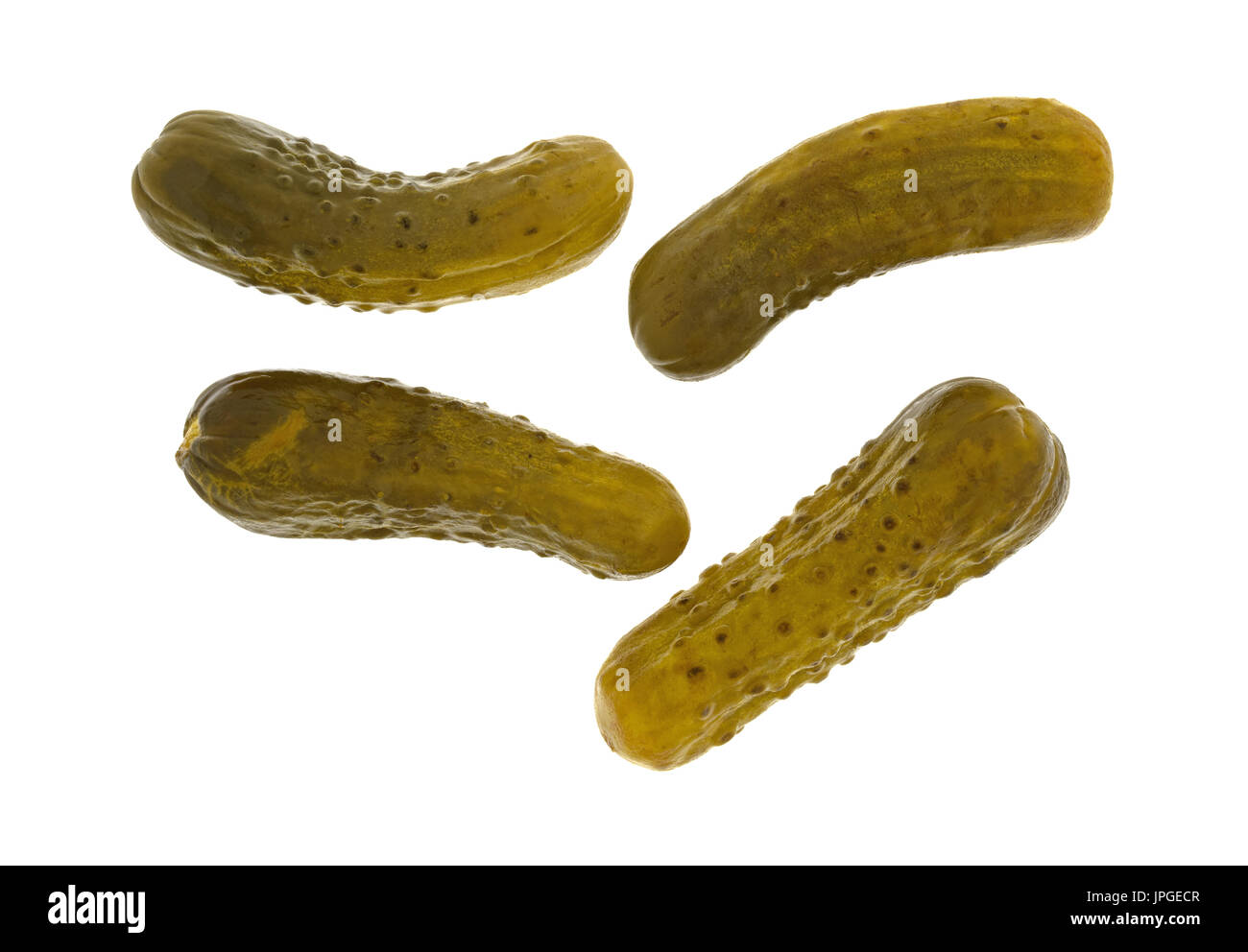 Top view of four kosher baby dill pickles isolated on a white ...