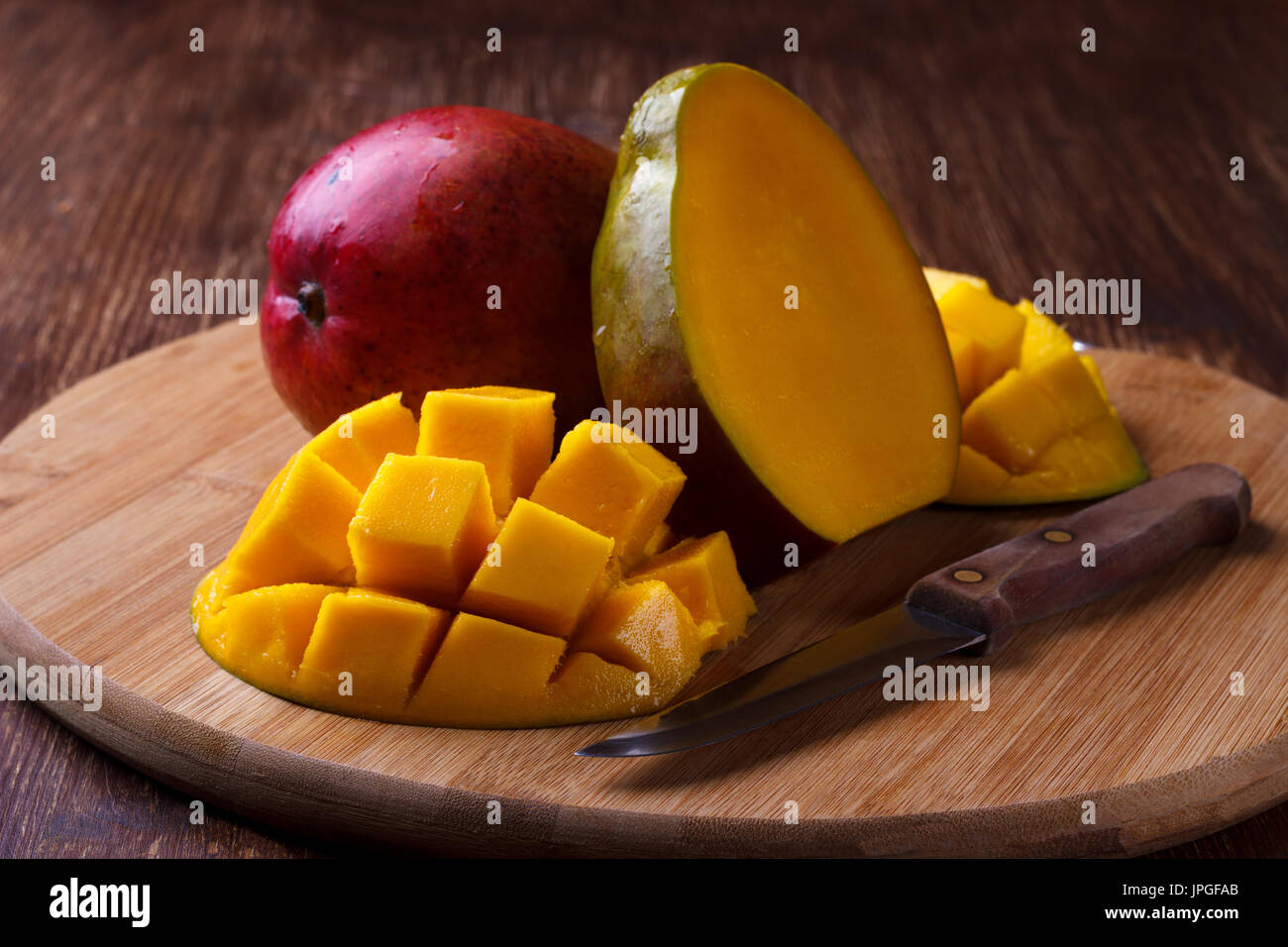 Fresh mango organic product on wooden background Stock Photo - Alamy