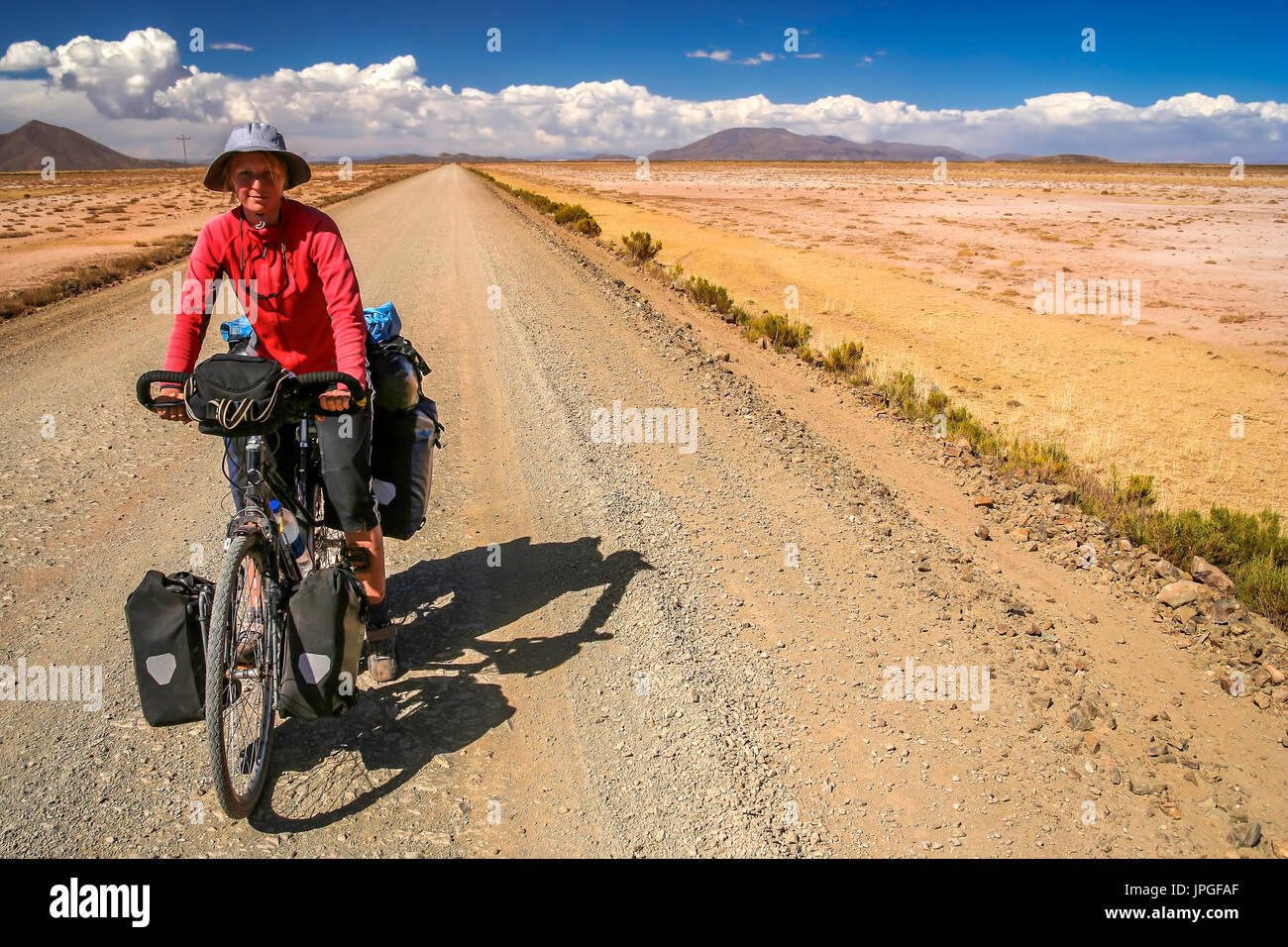 Woman cycling on the remote road in rural part of Bolivia Stock Photo ...