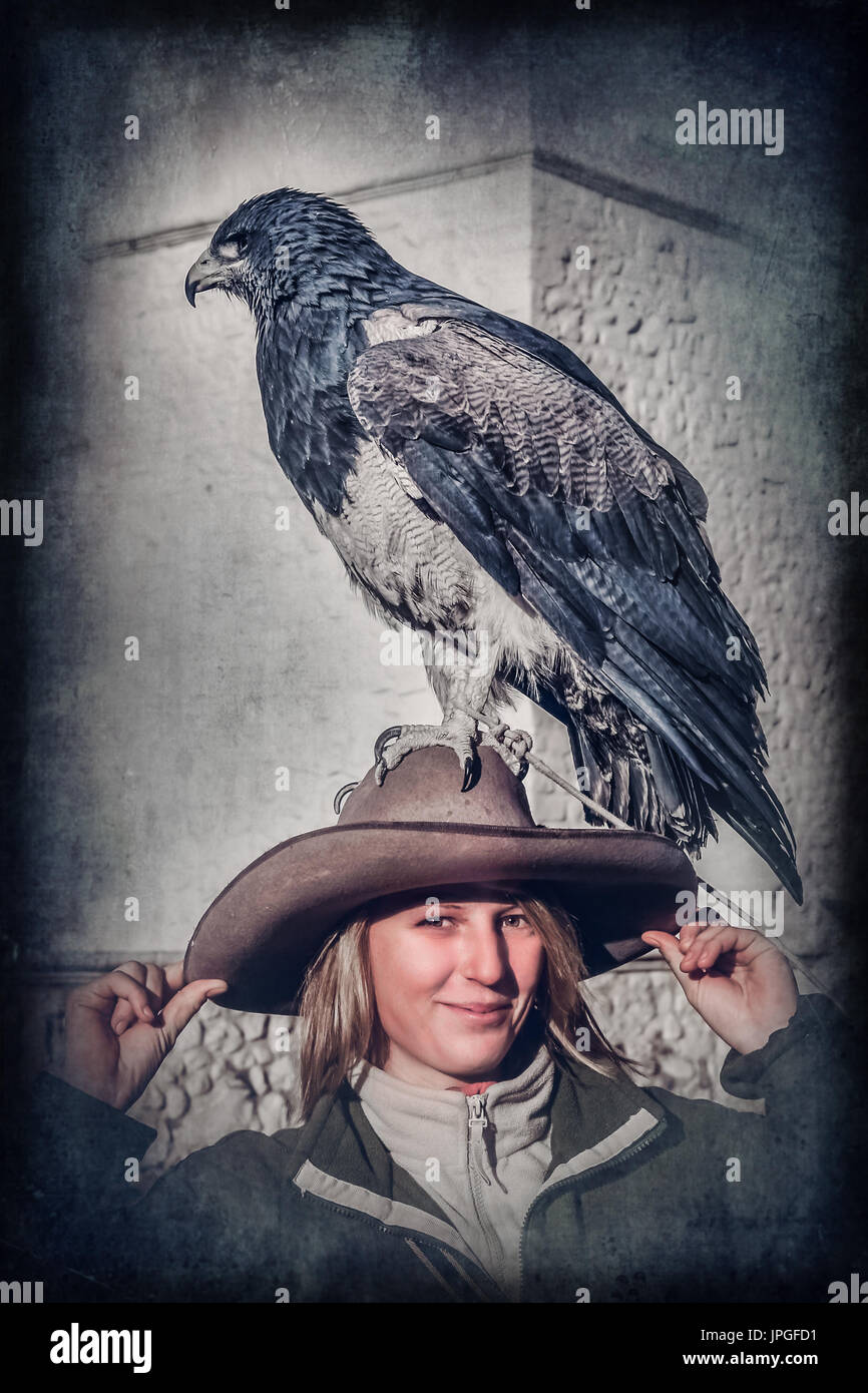 Female tourists with a native to the Andes eagle sitting calmly on her ...